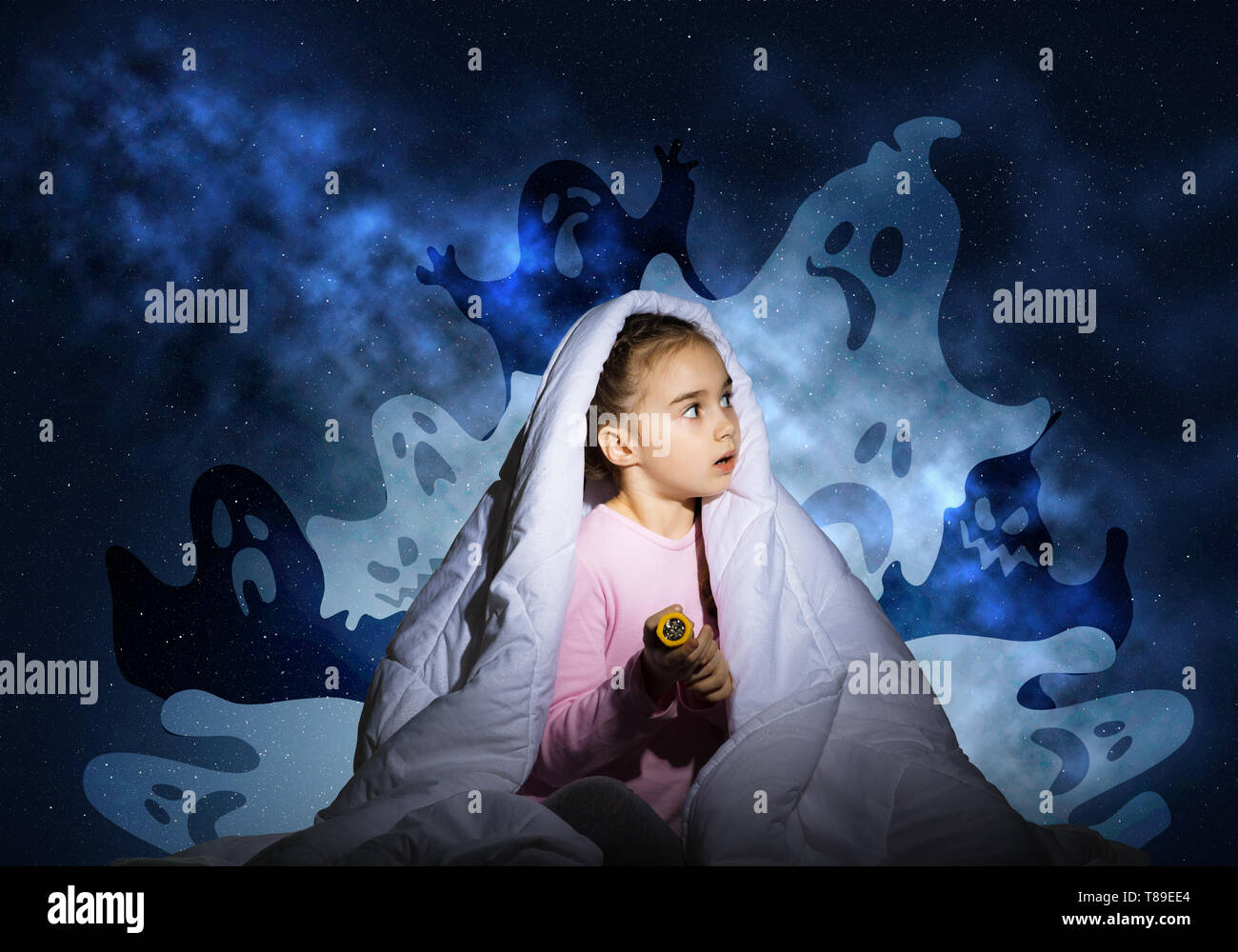 Scared girl with pillow hiding under blanket Stock Photo - Alamy