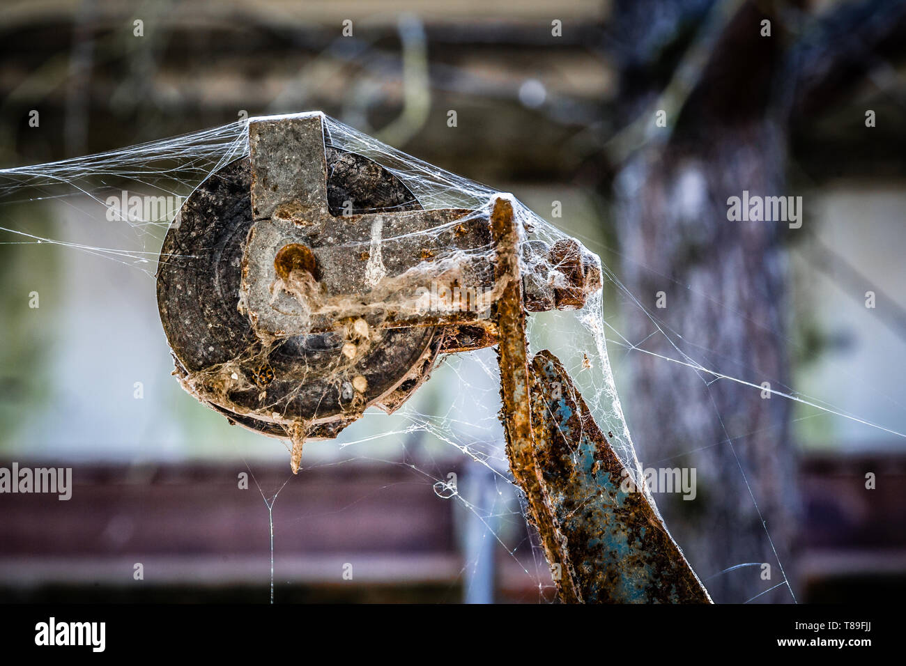 Rusted pulley with spider web in an abandoned farm in Belarus Chernobyl ...