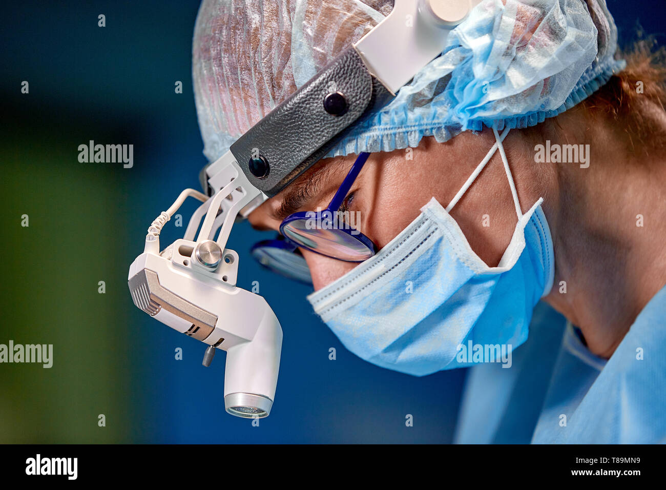 Female surgeon in operation room with reflection in glasses Stock Photo ...