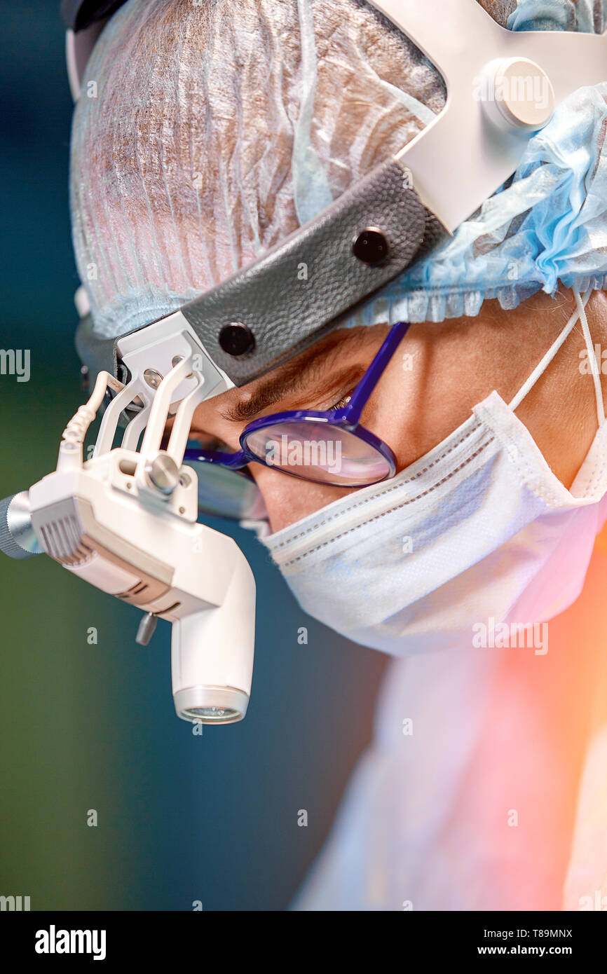 Female surgeon in operation room with reflection in glasses Stock Photo ...
