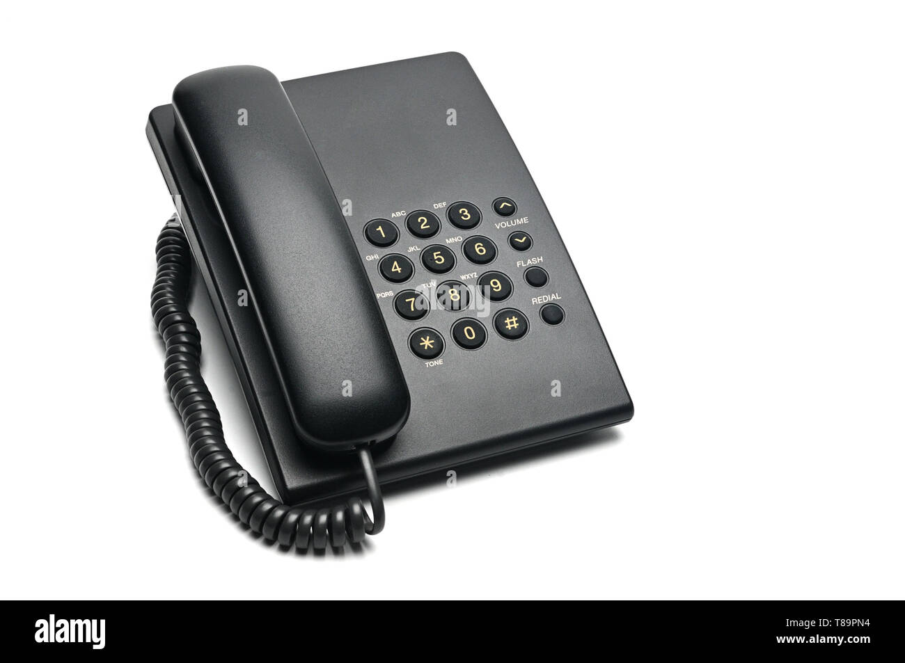 Classic wired telephone used at home and in offices on a white isolated ...