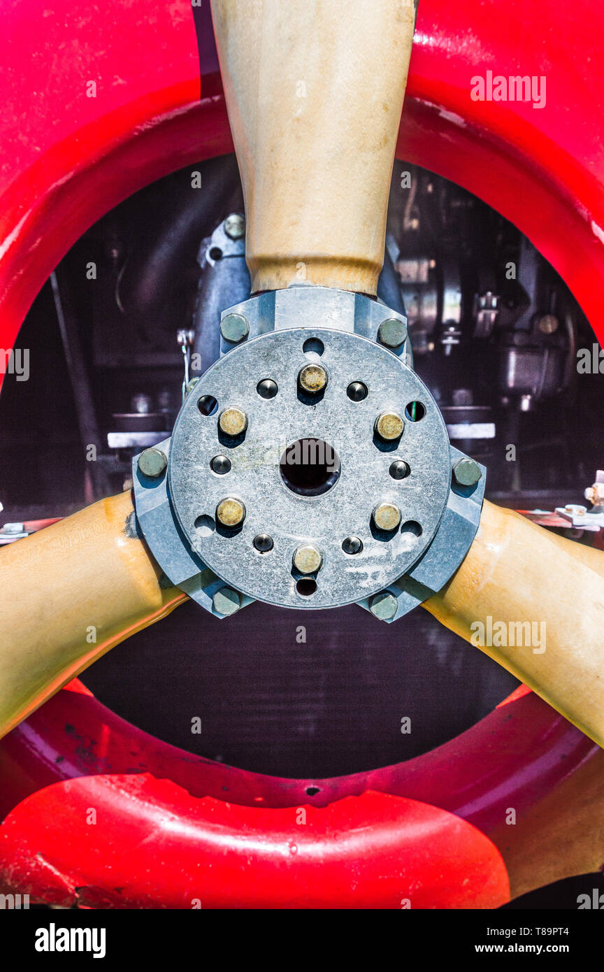 Close front view detail of vintage red biplane propeller, engine ...