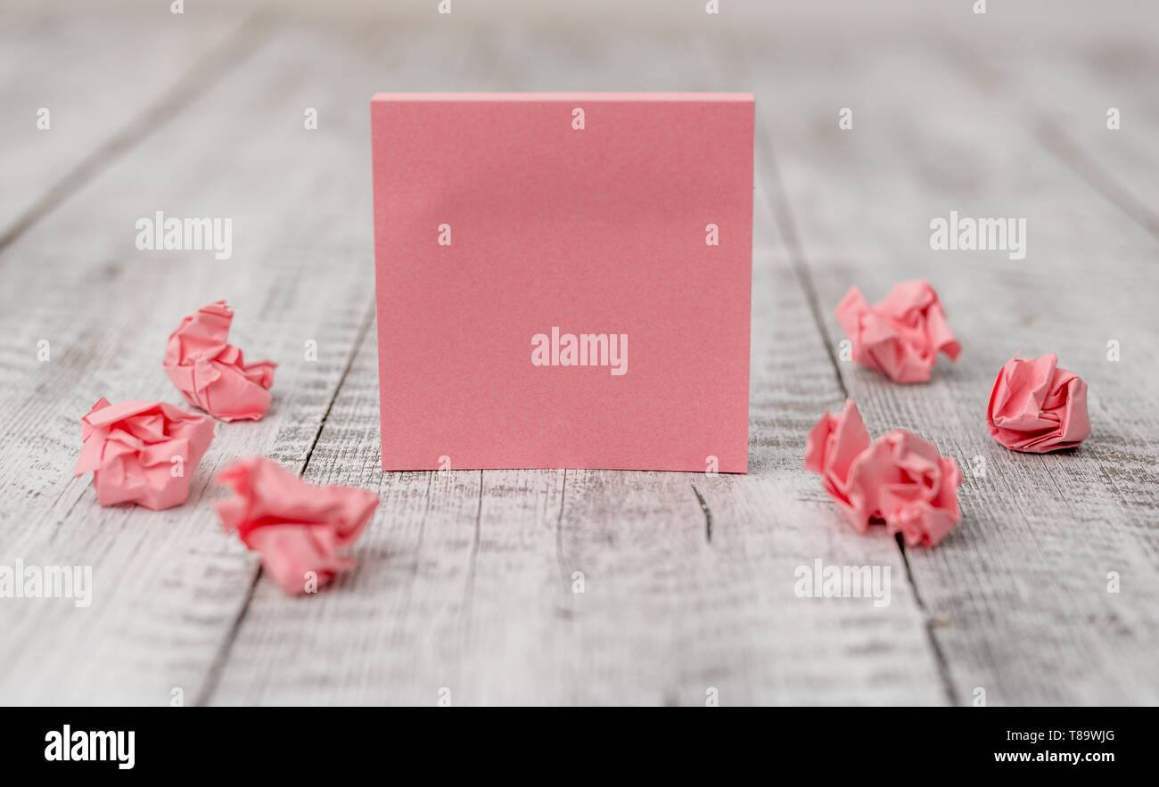 Thick set of plain note paper with scraps on the wooden textured table ...