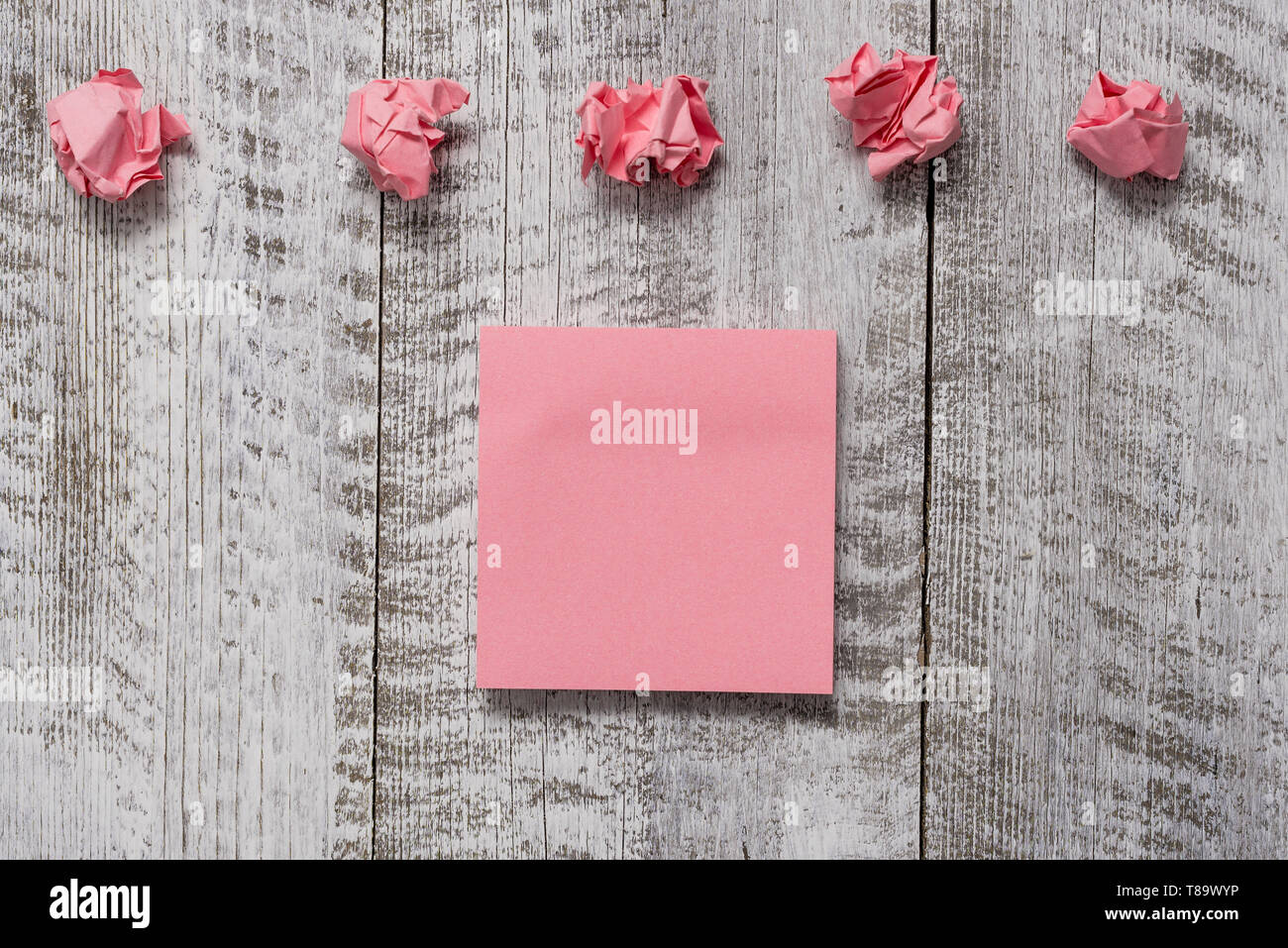 Thick set of plain note paper with scraps on the wooden textured table ...