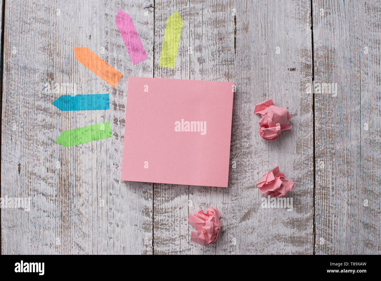 Plain note paper and line arrow stickers on the top of wooden table ...