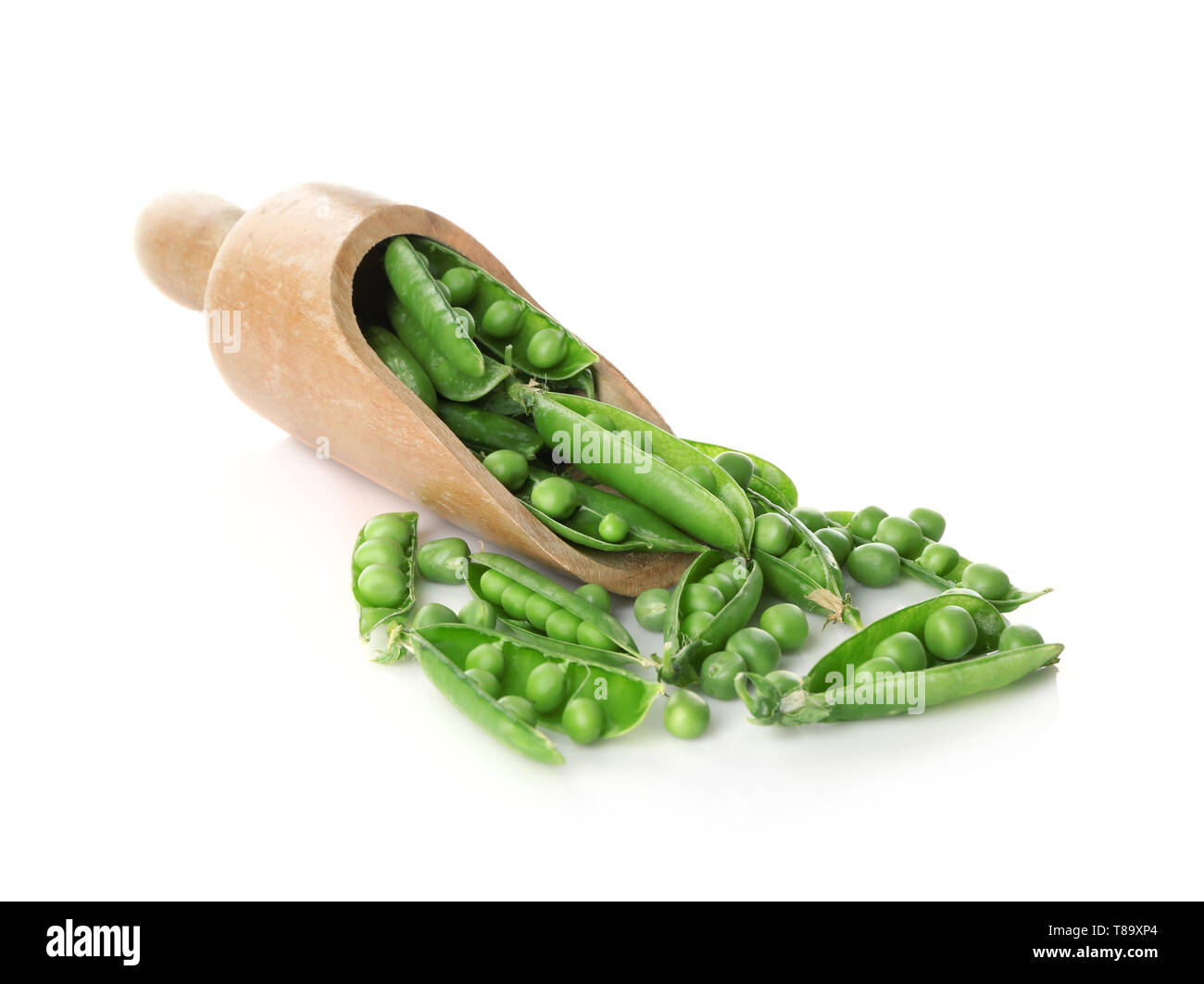 Scoop with green peas on white background Stock Photo - Alamy