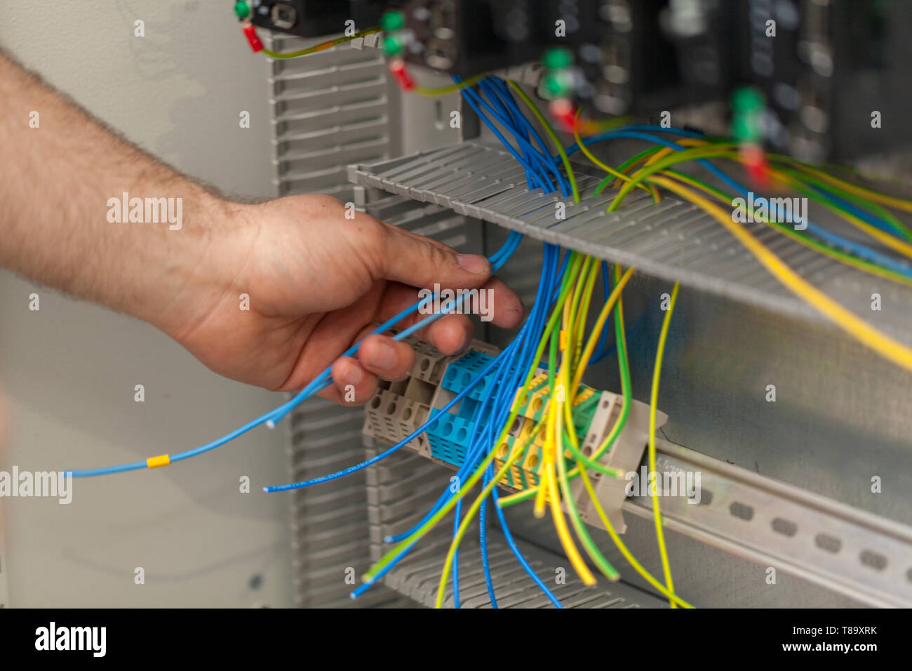electrician connecting wire on the control panel, close up Stock Photo ...