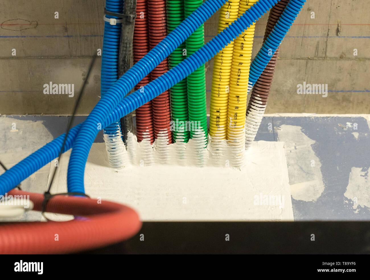 colorful plastic tubes for electrical wires in the sub ceiling in a ...