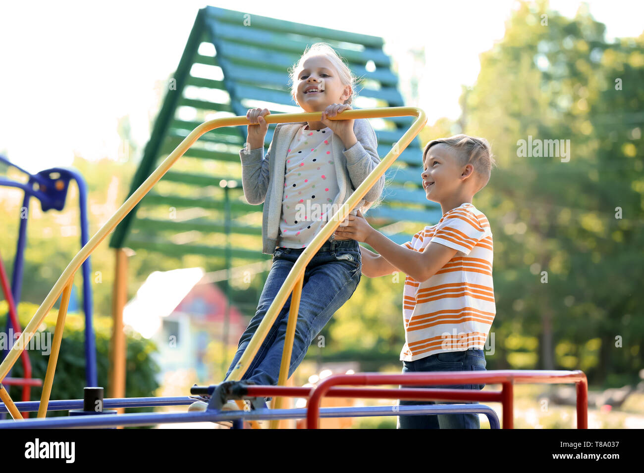 Cute little children having fun outdoors on playground Stock Photo - Alamy