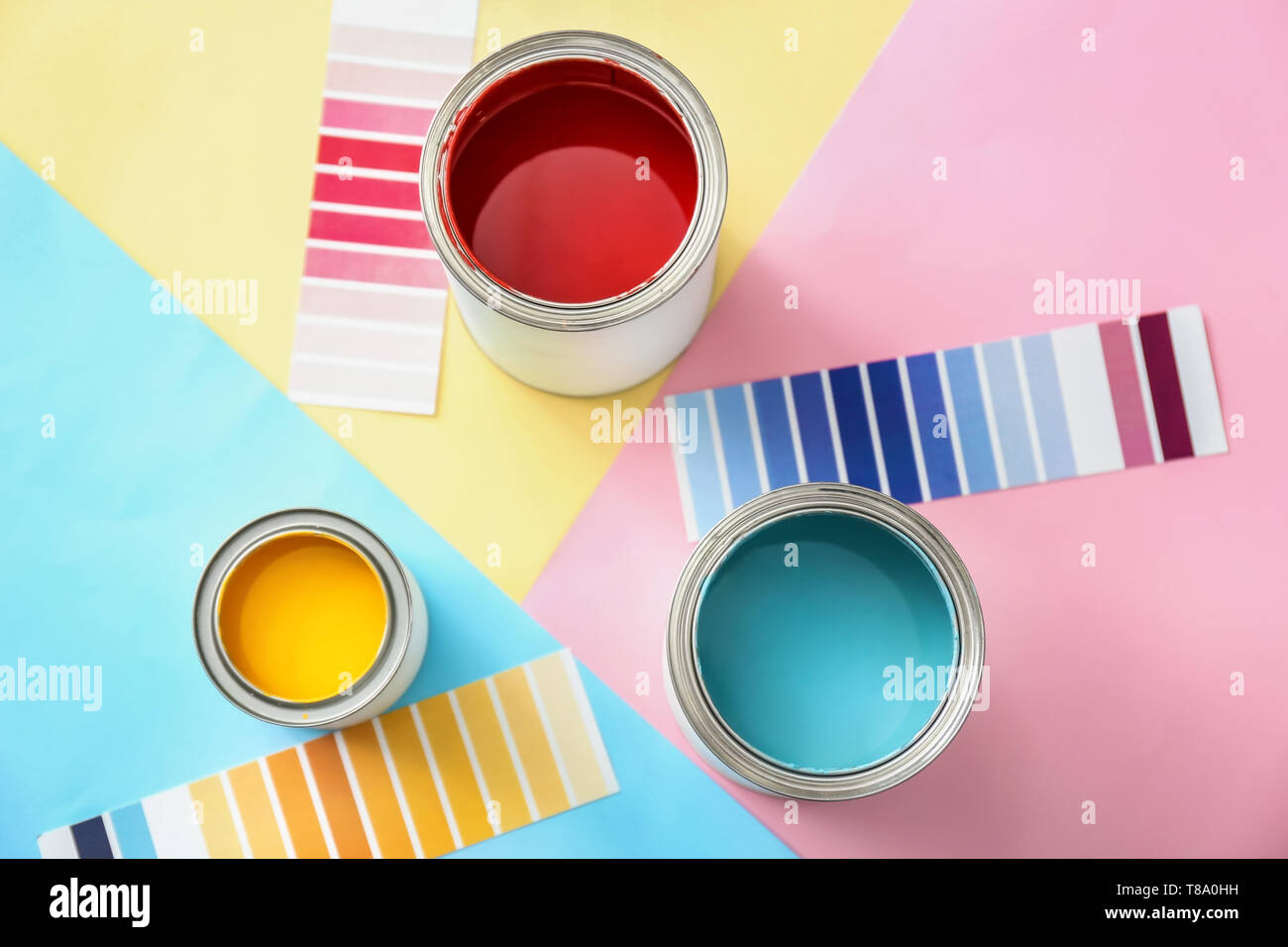 Paint cans with palette samples on color background Stock Photo - Alamy