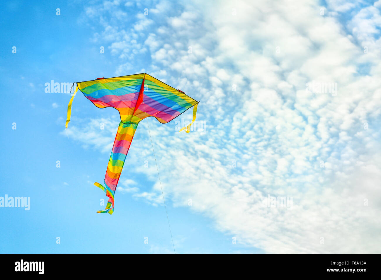 Beautiful kite flying in blue sky Stock Photo - Alamy