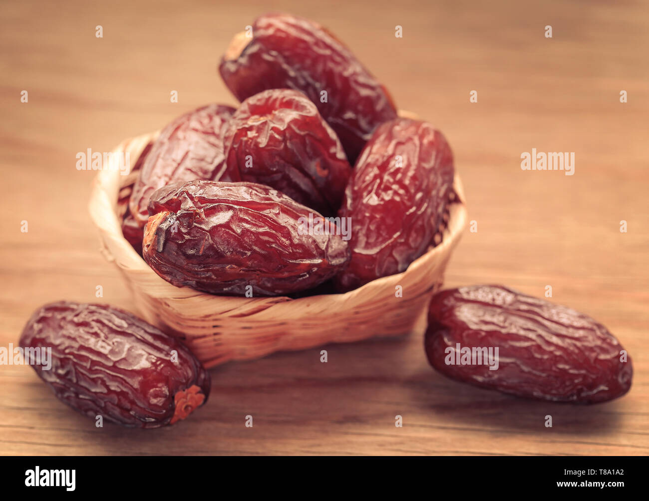 Arabian Dates on wooden surface Stock Photo - Alamy