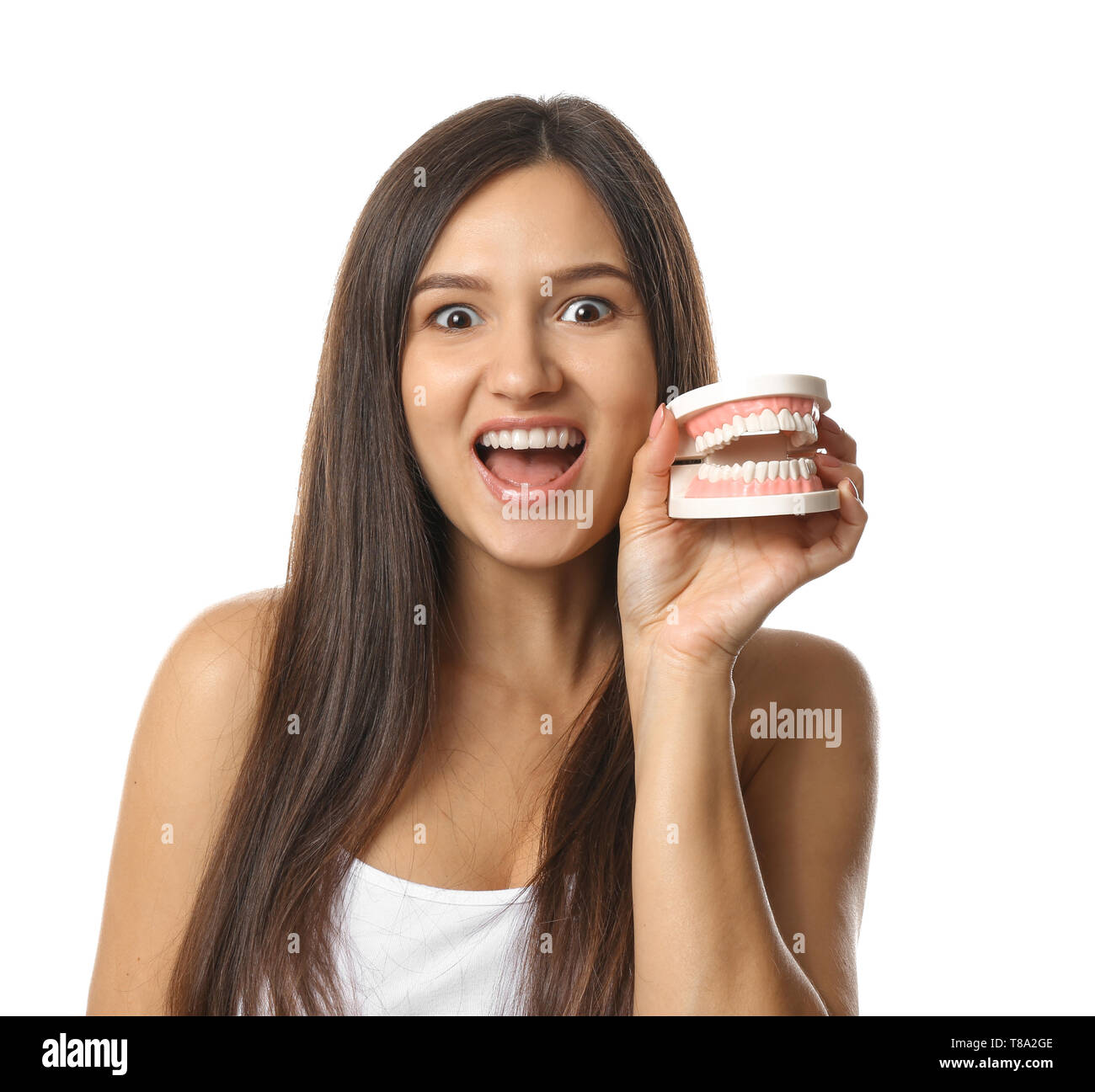 Beautiful young woman with artificial jaw on white background Stock ...