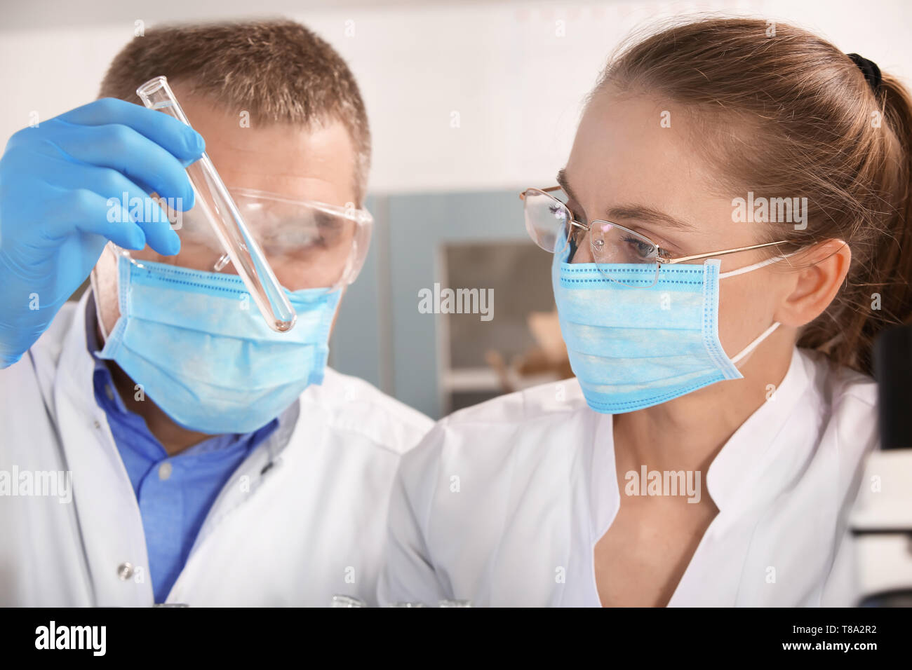 Female and male scientists working in laboratory Stock Photo - Alamy