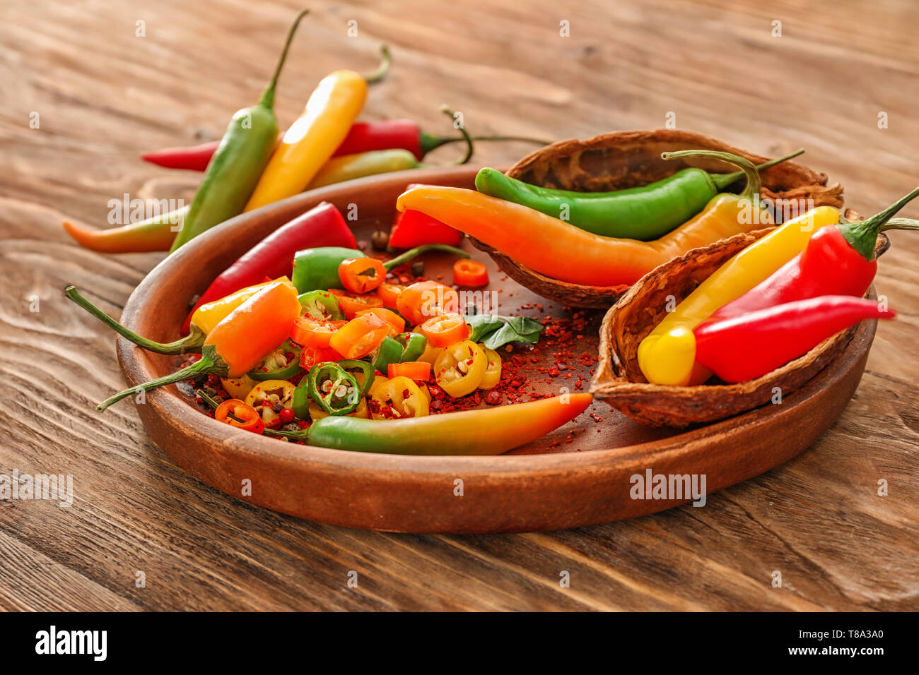 Plate with fresh chili peppers on wooden background Stock Photo - Alamy