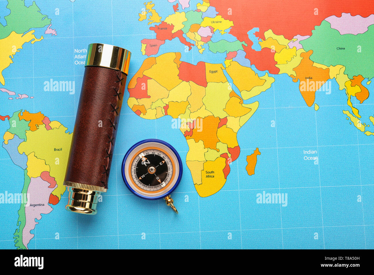 Spyglass and compass on world map. Travel planning concept Stock Photo ...
