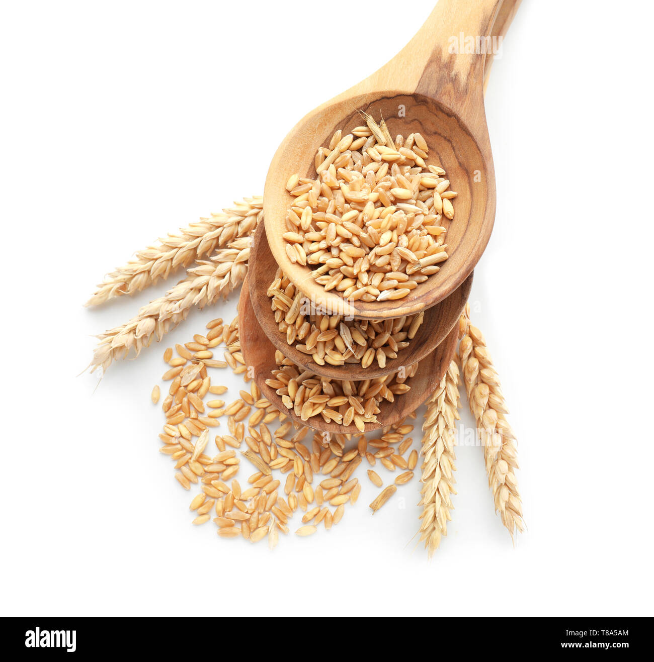 Spoons with wheat grains and spikelets on white background Stock Photo ...