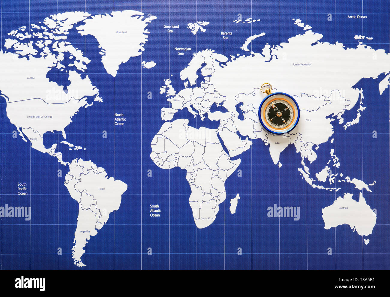 Modern compass on world map Stock Photo - Alamy