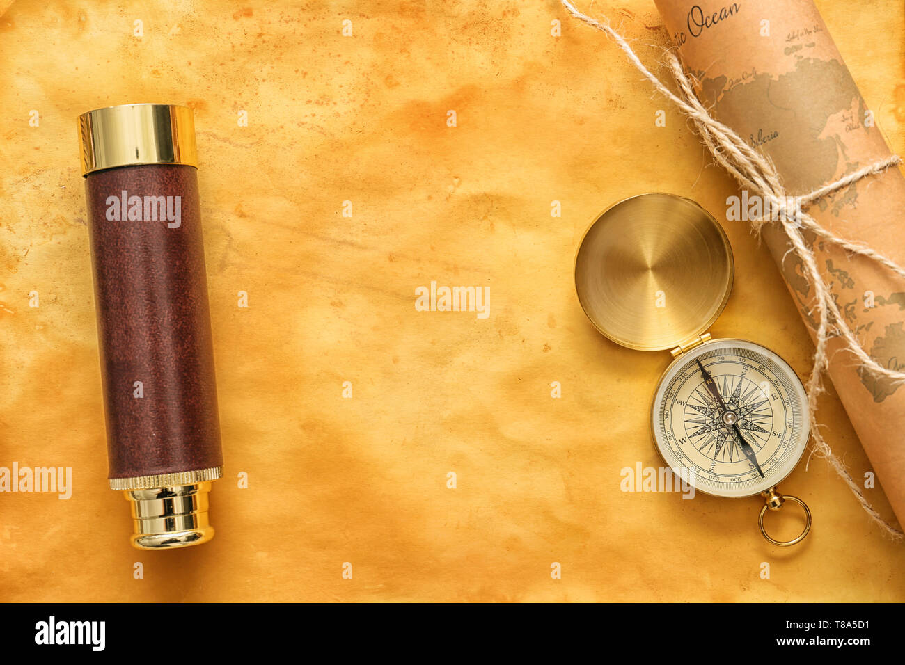 Vintage compass with spyglass and world map on old paper, top view ...