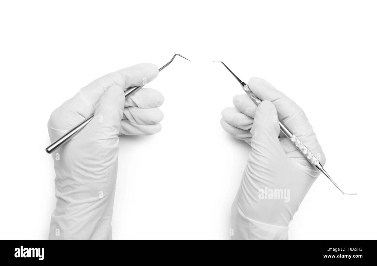 Dentist with tools on white background Stock Photo - Alamy