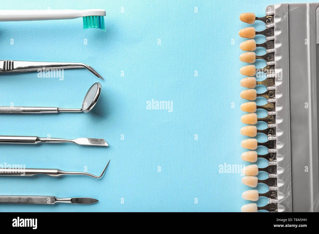 Dentist tools with teeth samples and brush on color background Stock ...