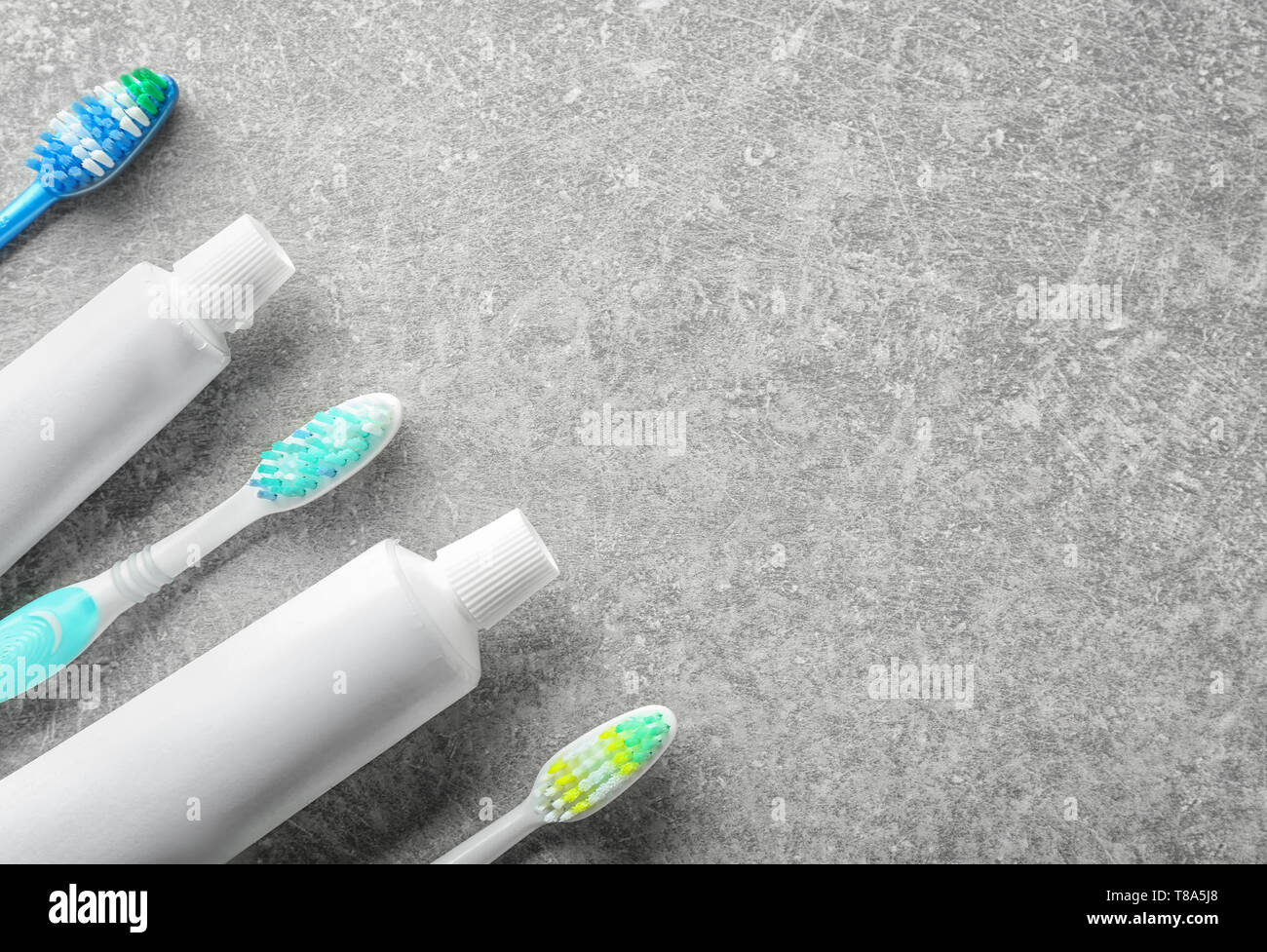Toothbrushes with paste on light background Stock Photo - Alamy
