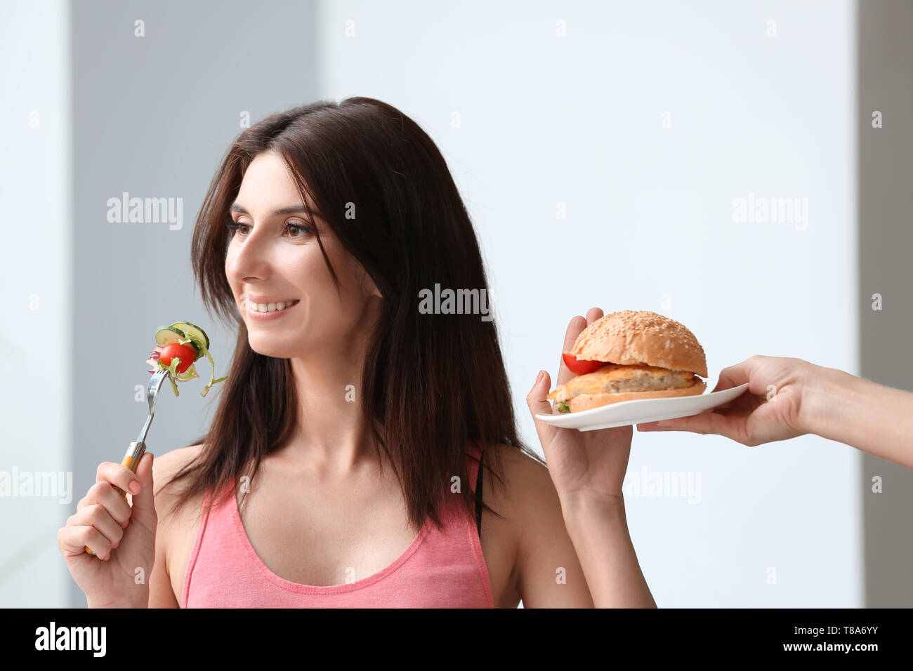 Woman refusing to eat unhealthy food indoors. Diet concept Stock Photo ...