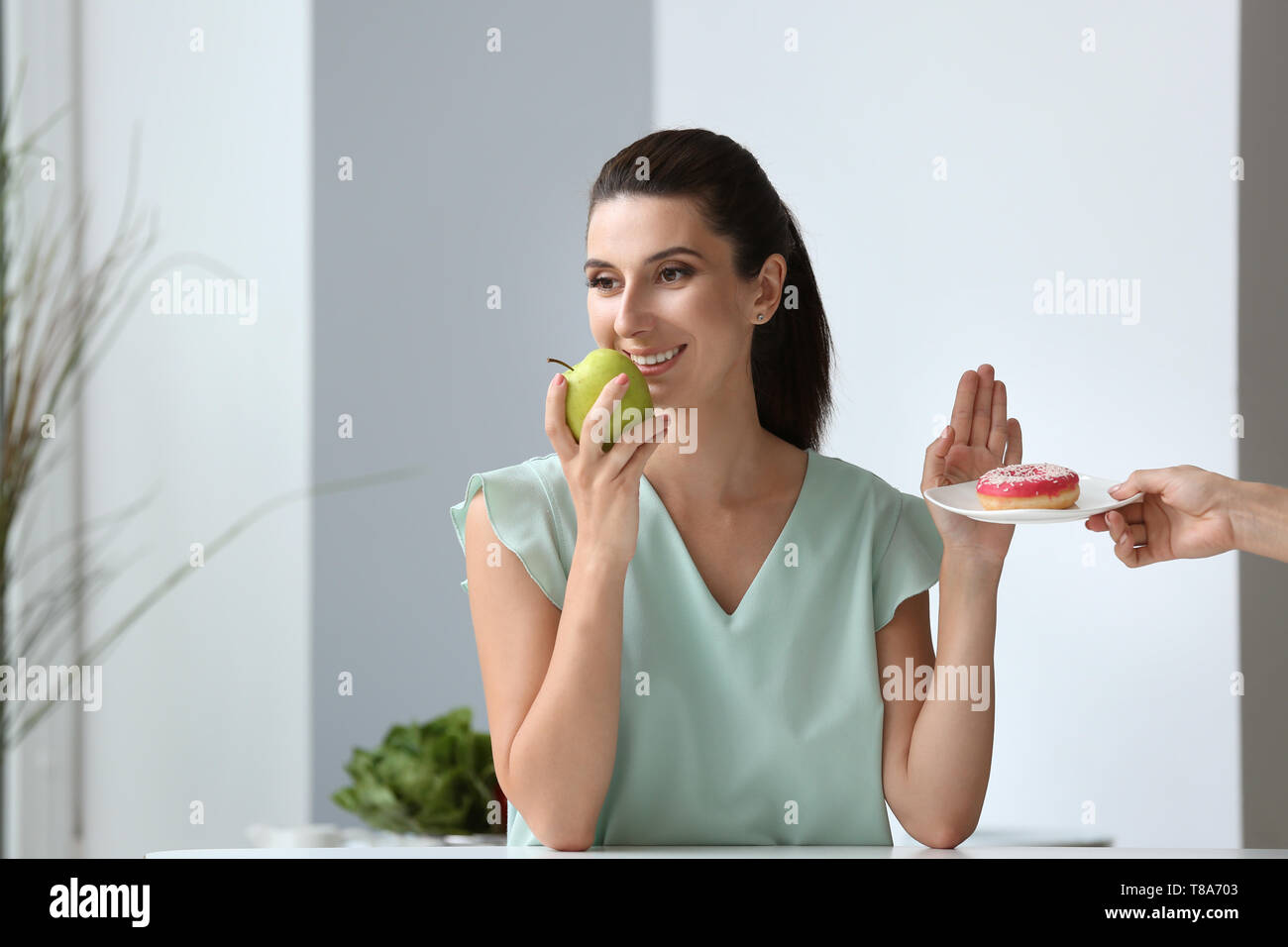Woman refusing to eat unhealthy food indoors. Diet concept Stock Photo ...