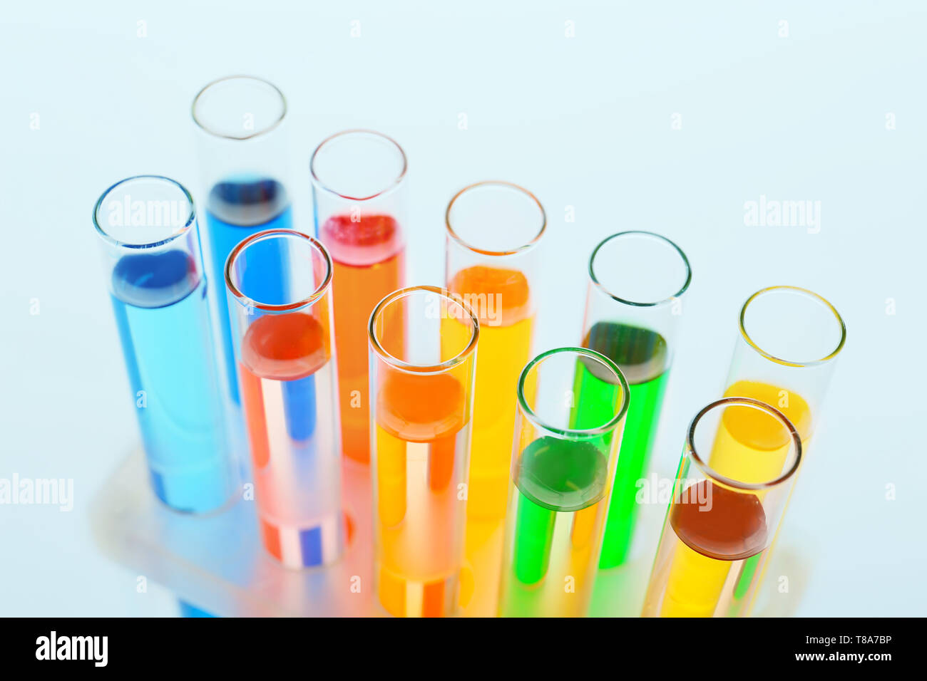 Test tubes with colorful liquids in holder on white background Stock ...