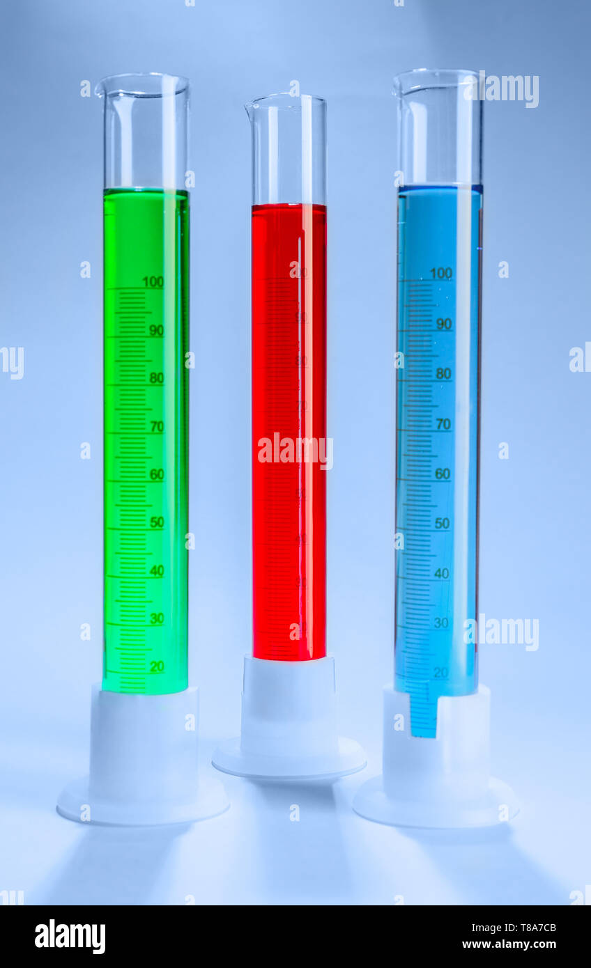 Graduated cylinders with different liquids on light background Stock ...