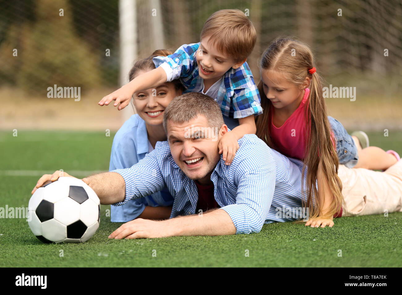 Happy family with soccer ball outdoors Stock Photo - Alamy
