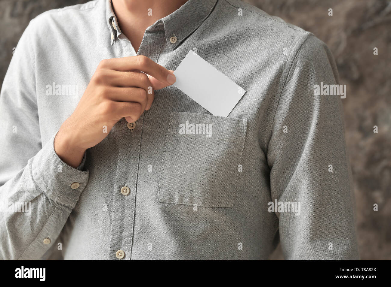 Man putting business card into pocket, closeup Stock Photo - Alamy