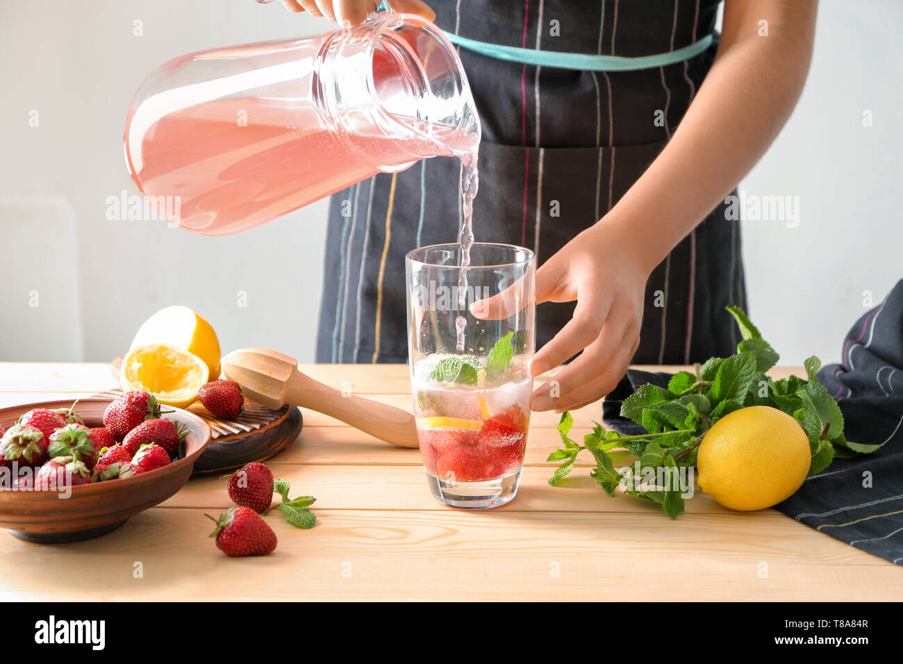 Woman pouring tasty lemonade hi-res stock photography and images - Alamy