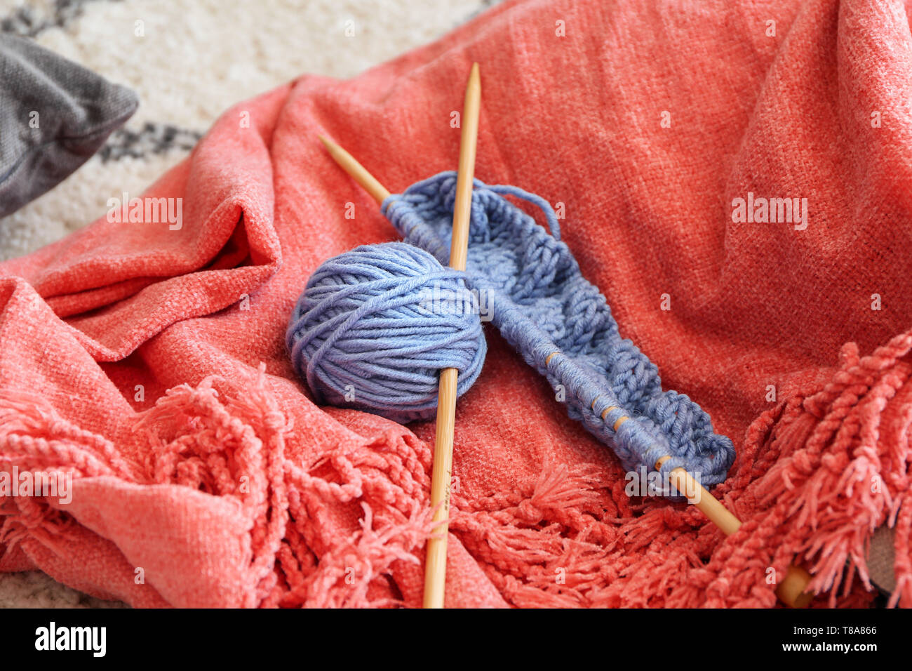 Knitting yarn with unfinished clothes on soft plaid Stock Photo - Alamy