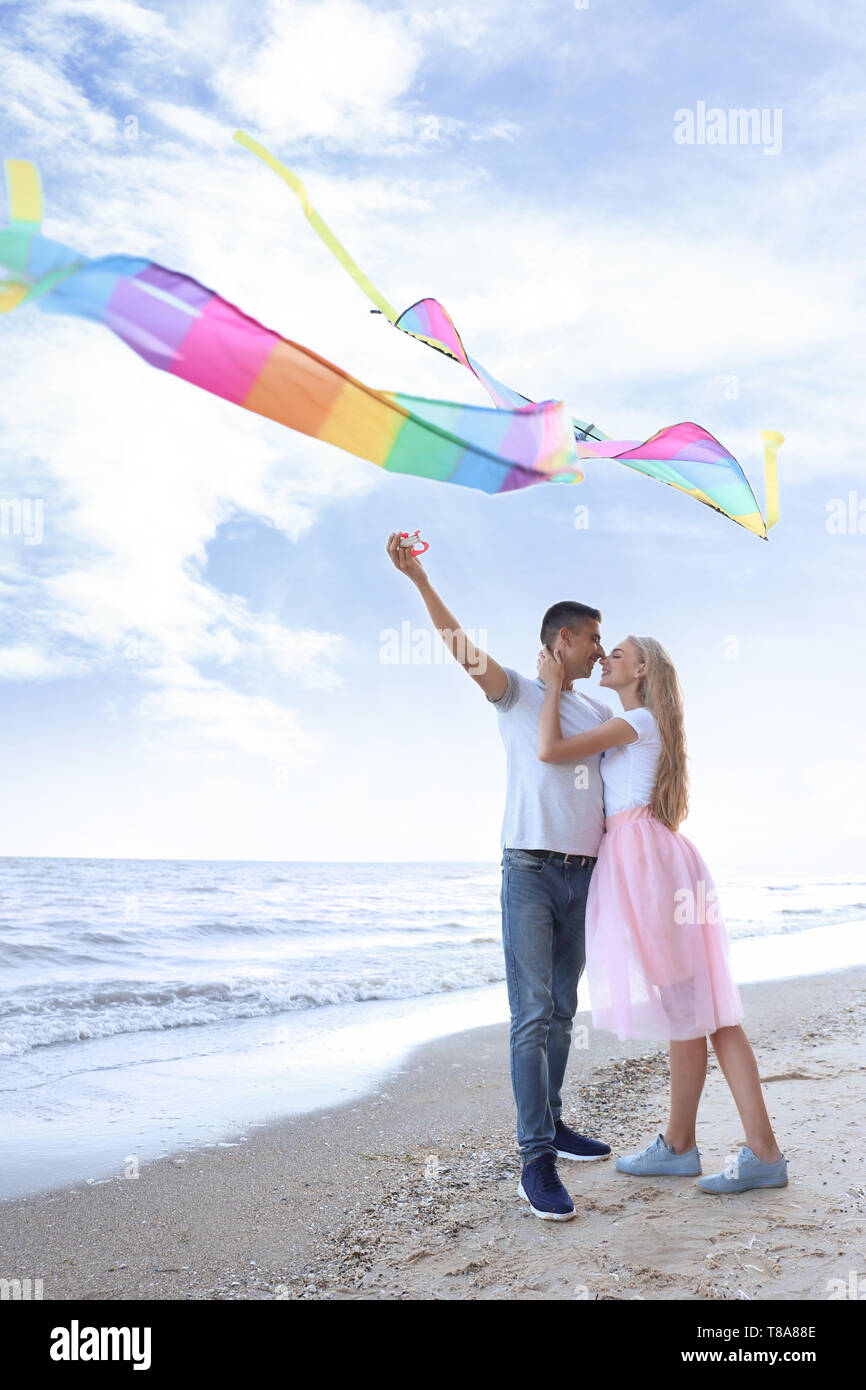 Young romantic couple flying kite hi-res stock photography and images ...