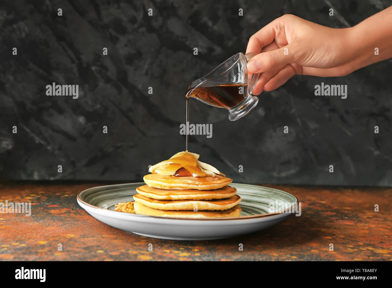 Woman hand pouring maple syrup hi-res stock photography and images - Alamy
