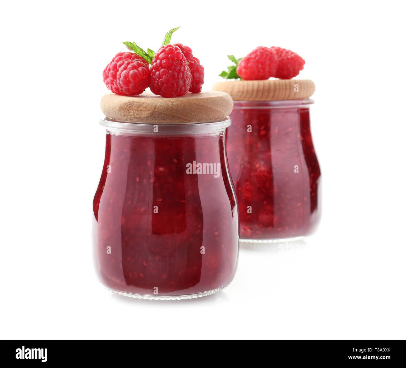 Glass jars with raspberry jam on white background Stock Photo - Alamy