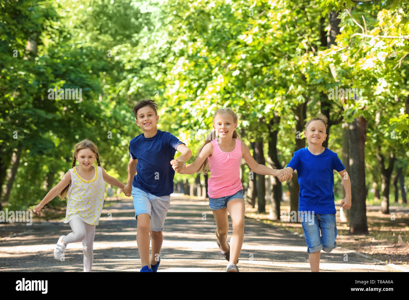 Cute little children playing in green park Stock Photo - Alamy