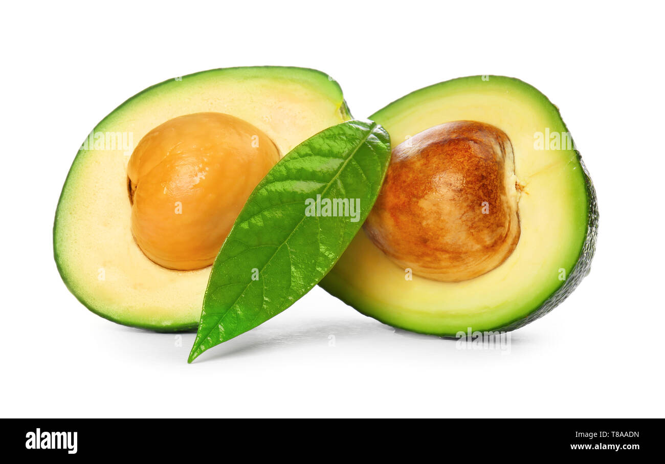 Halves of ripe avocados on white background Stock Photo - Alamy