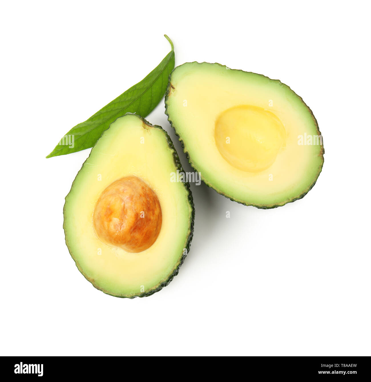 Halves of ripe avocado on white background Stock Photo - Alamy