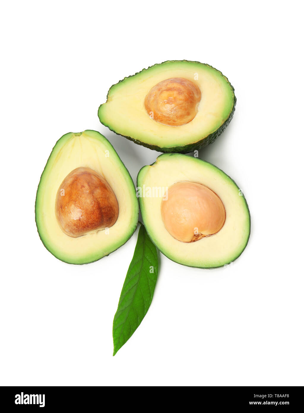 Halves of ripe avocados on white background Stock Photo - Alamy