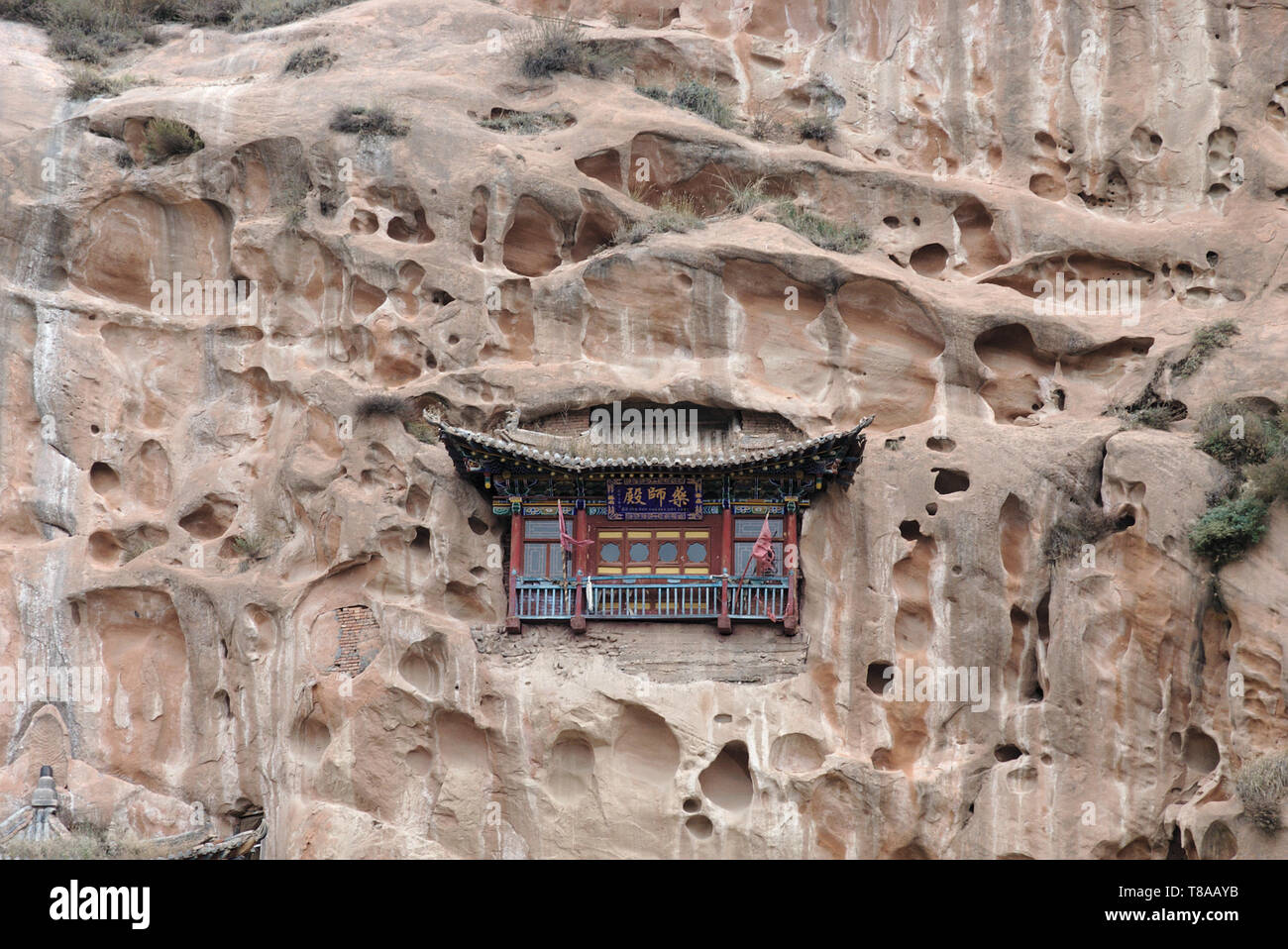Buildings carved out of cliff face, Thousand Buddha Temple, Mati Si ...