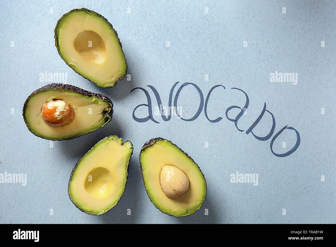 Composition with halves of ripe avocados on color background Stock ...