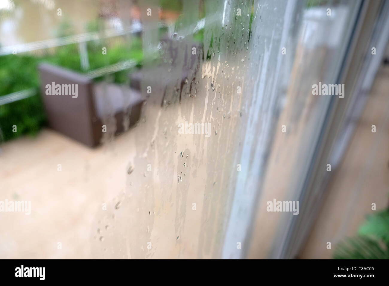 Rain drops on the glass window with cafe Background Stock Photo - Alamy