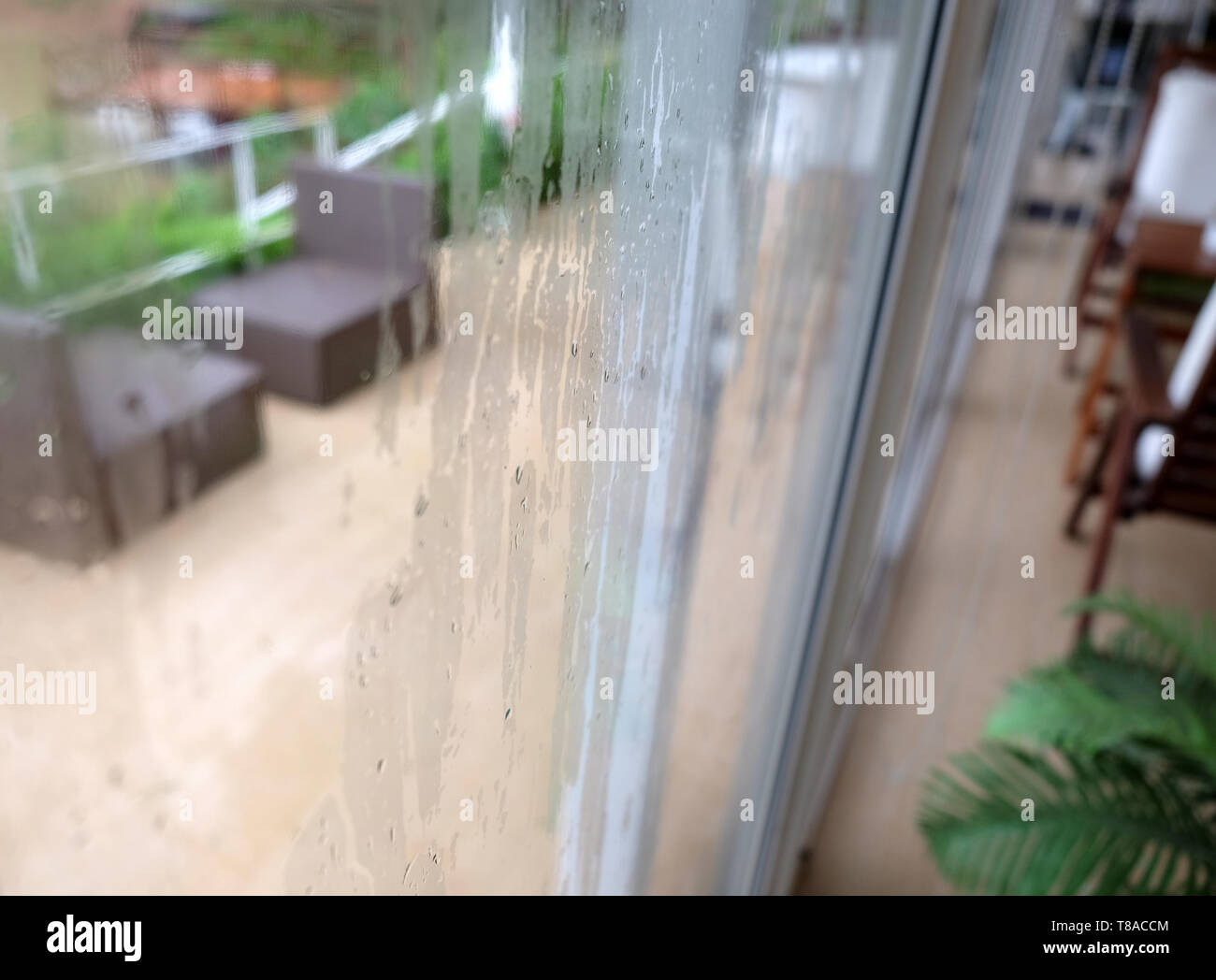 Rain drops on the glass window with cafe Background Stock Photo - Alamy