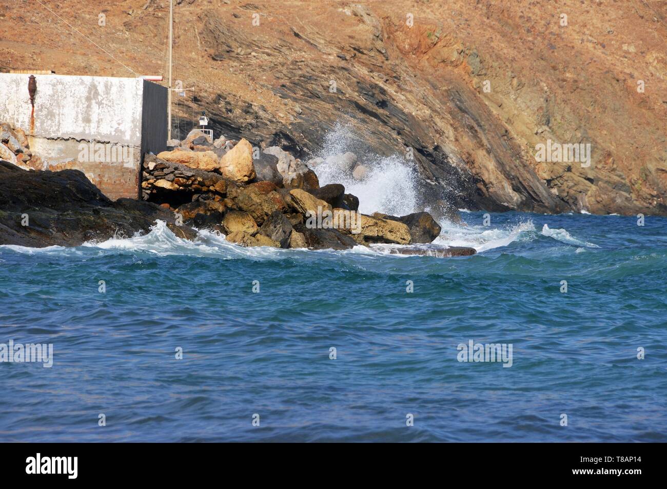 Waves breaking on a jetty in Crete Stock Photo - Alamy