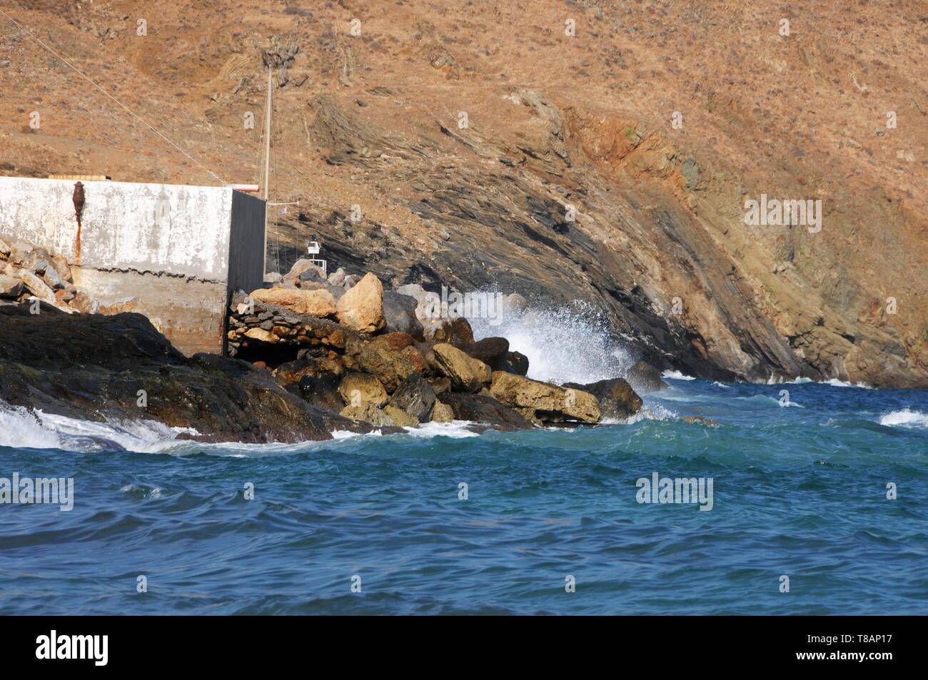 Waves breaking on a jetty in Crete Stock Photo - Alamy