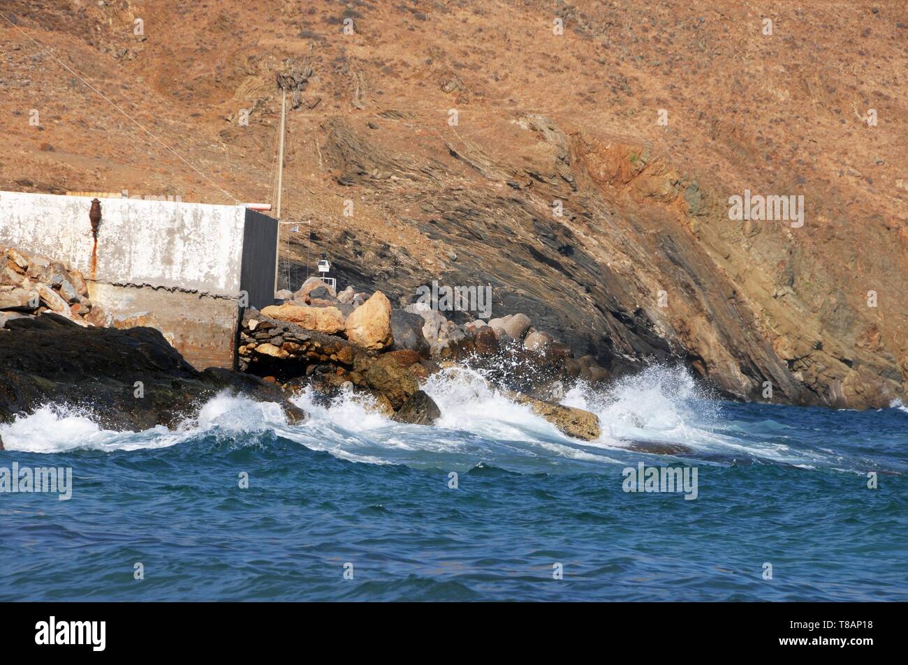 Waves breaking on a jetty in Crete Stock Photo - Alamy