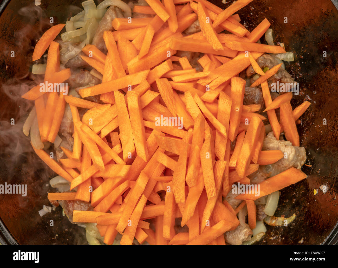 step-by-step process of cooking pilaf in a cast iron cauldron Stock ...