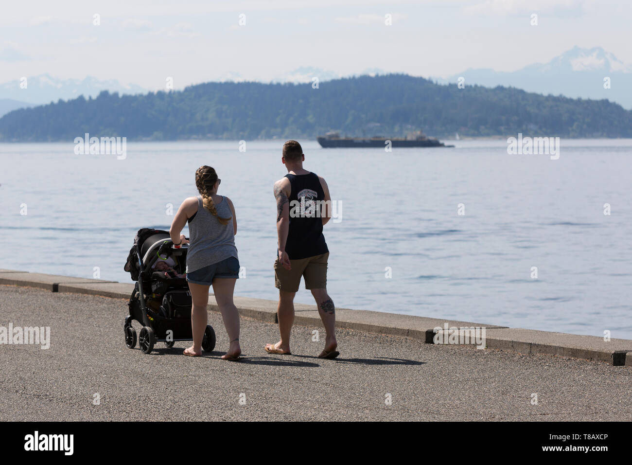 Seattle, Washington: A young couple walks along Alki Trail in West ...